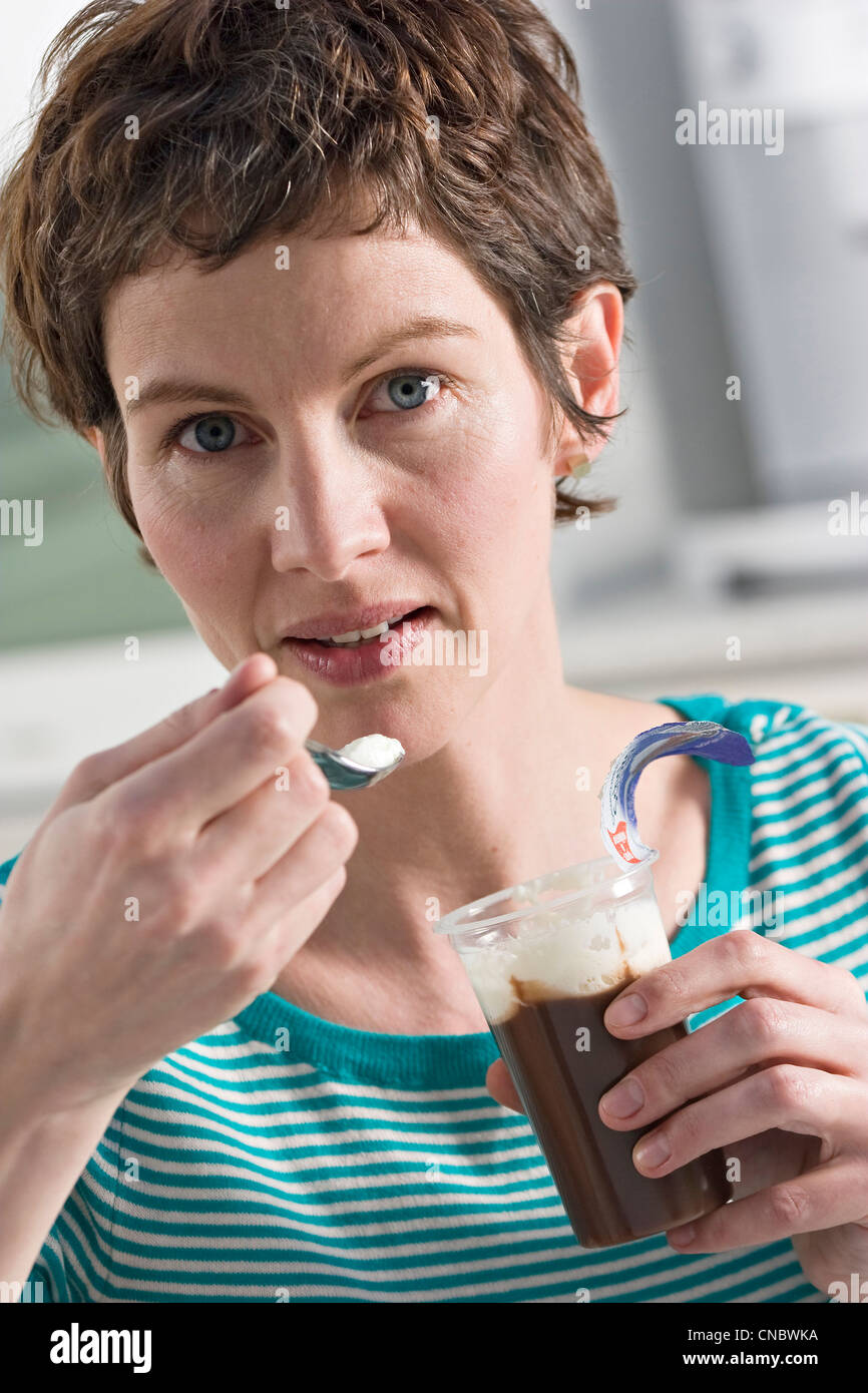Woman eating chocolate pudding hi-res stock photography and images - Alamy