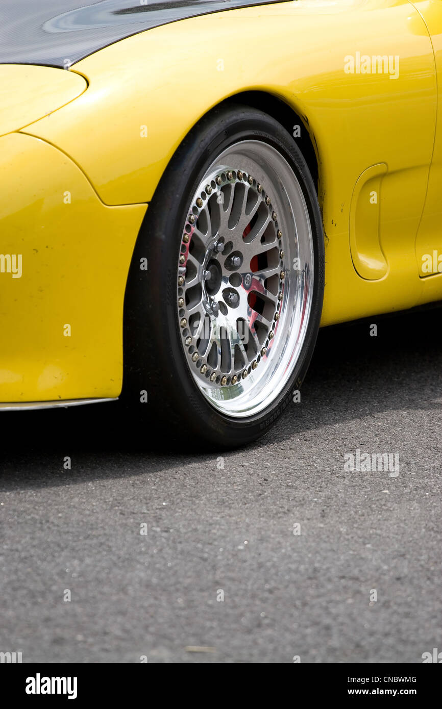 A closeup of the custom rims on a modern sports car with plenty of ...