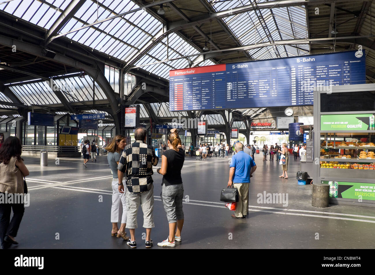 Horizontal wide angle of the destinations board on the busy concourse ...