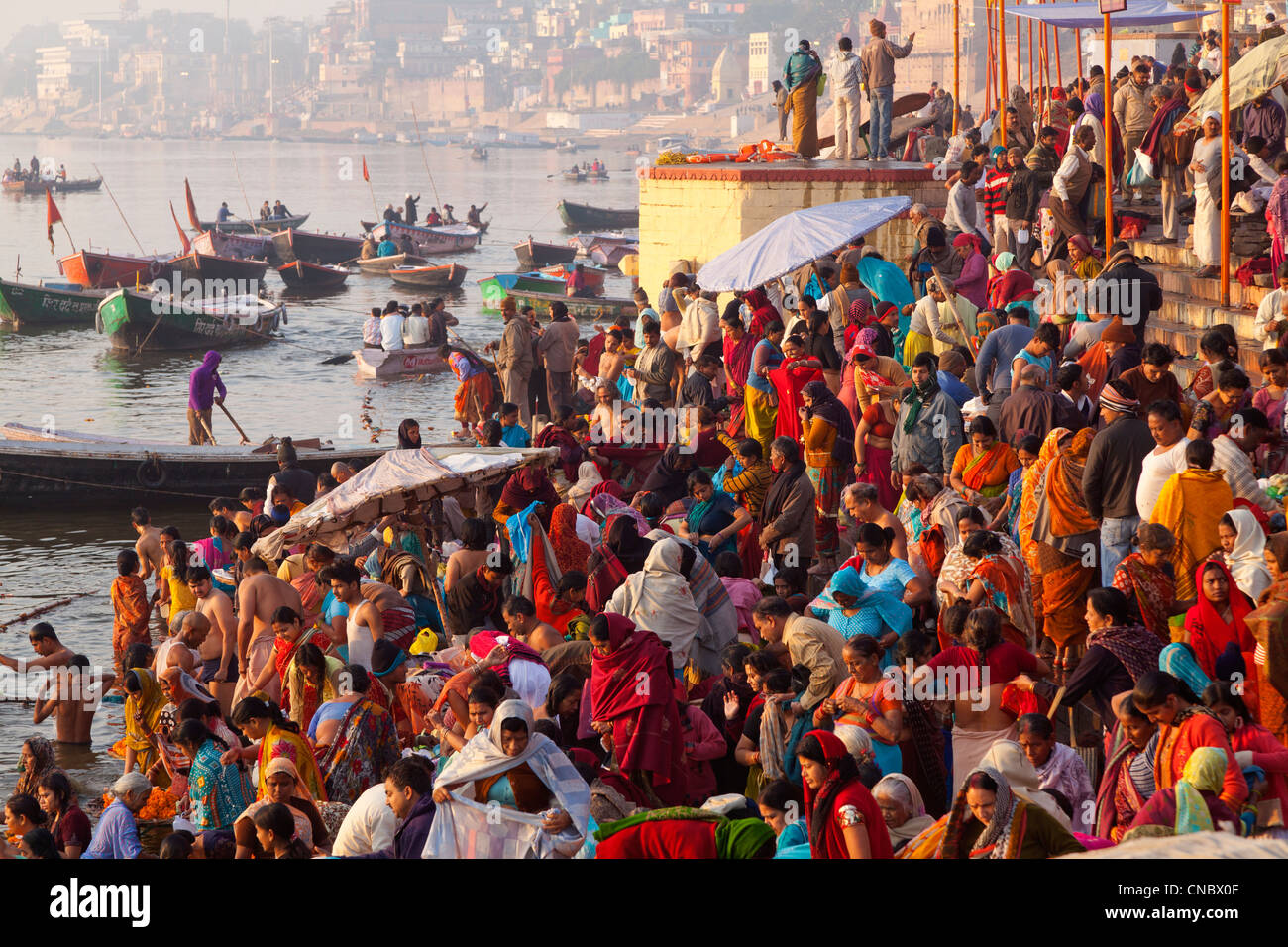 India, Uttar Pradesh, Varanasi, Pilgrims bathing and praying in the ...