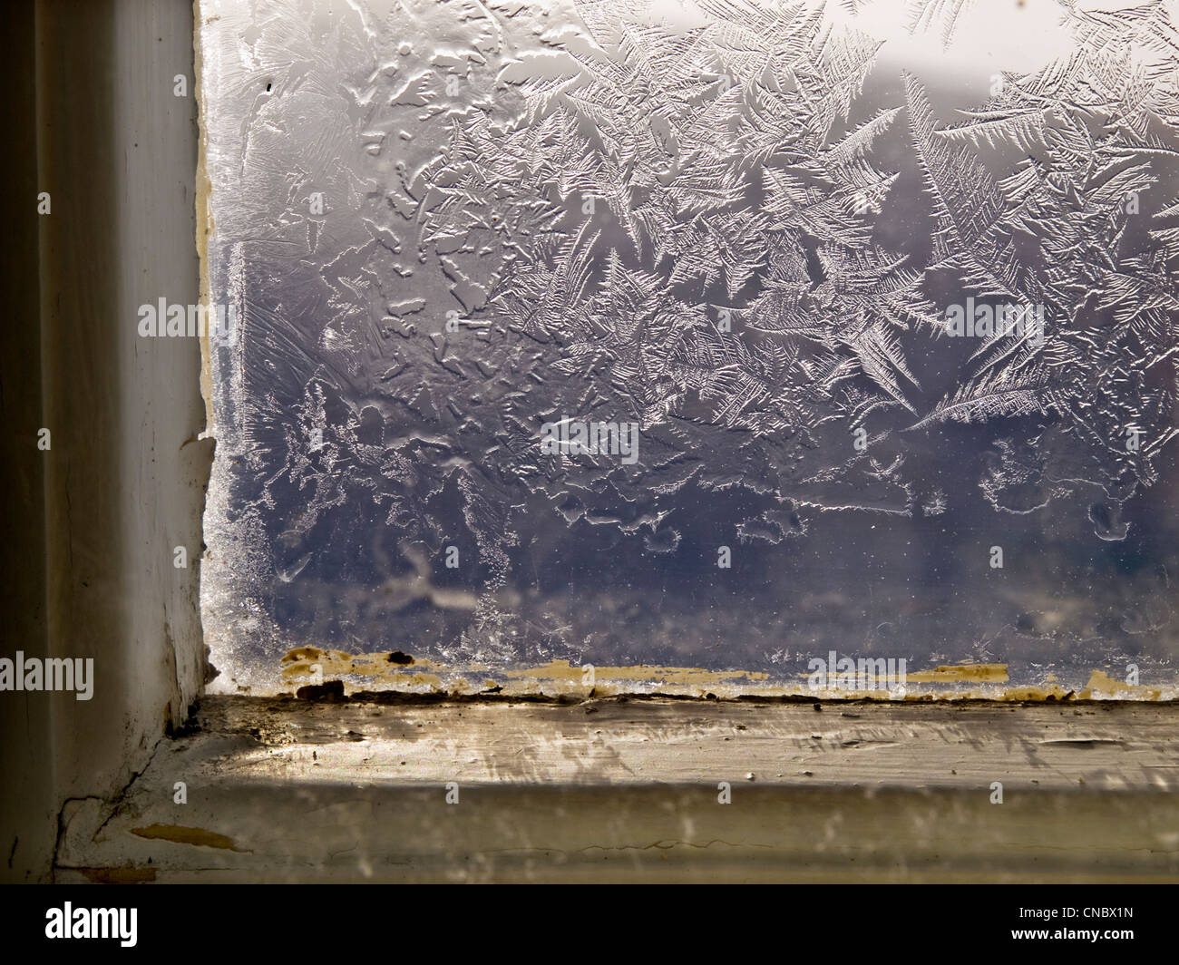 Frost on glass, shabby window frame of a mountain hut Stock Photo - Alamy