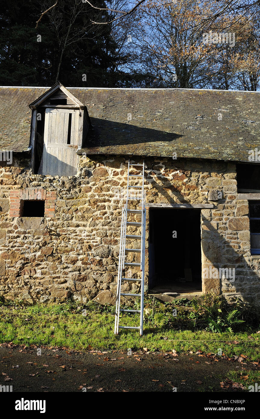 A scale is placed on an old building on a farm in Normandy to do work ...