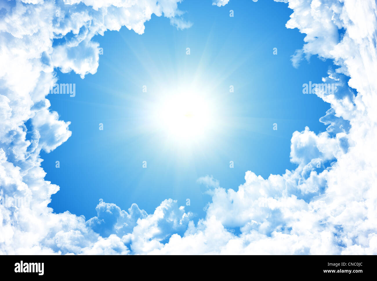 Sun in bright blue sky Stock Photo - Alamy