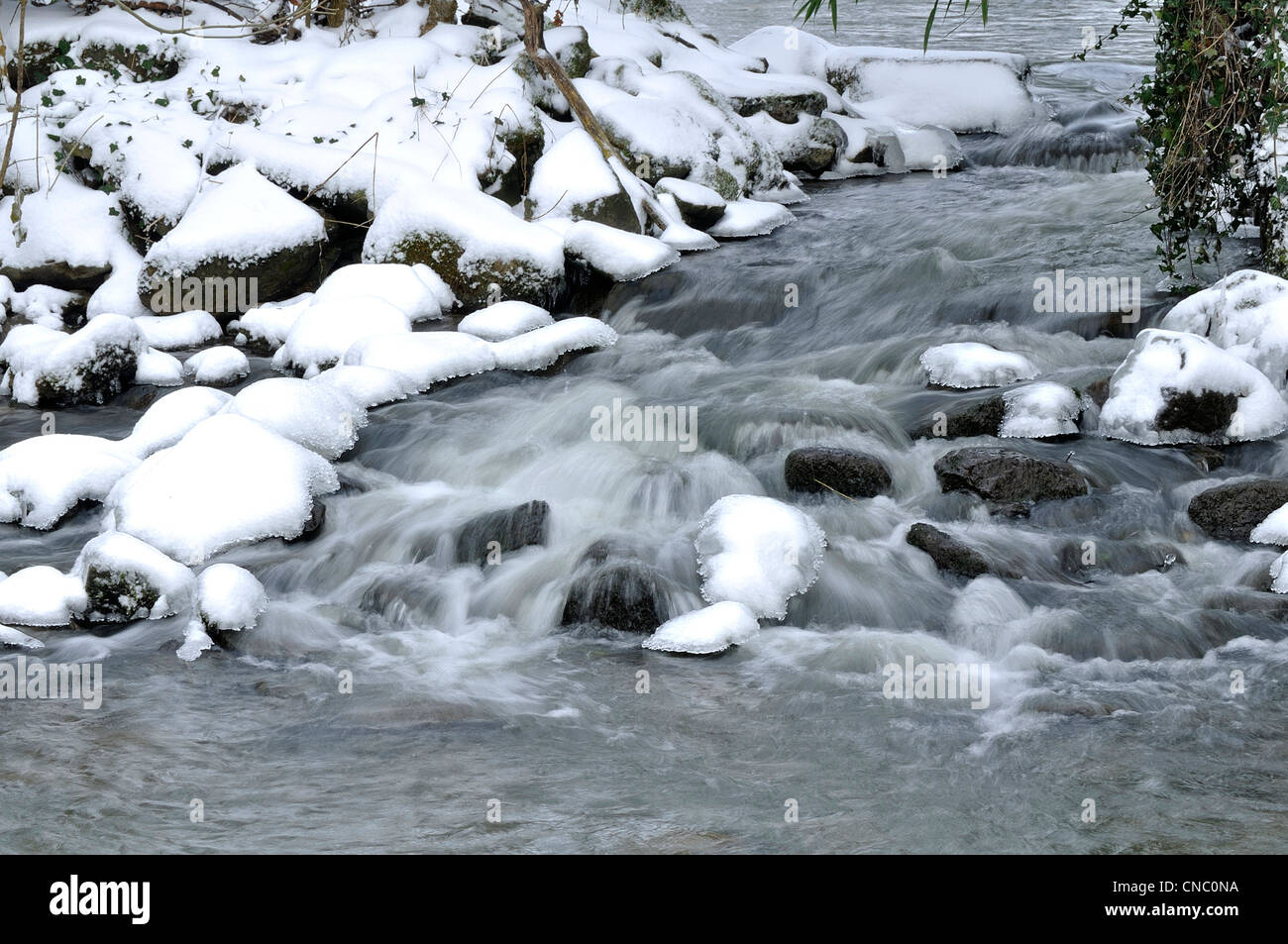 A dam on a river in winter, with snow on the stones, river : La Varenne ...