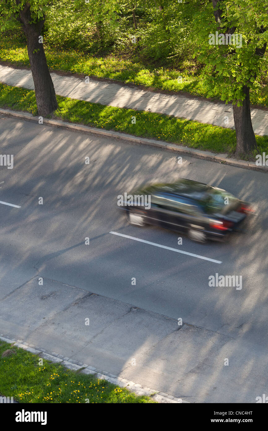 Speeding concept - Cars moving fast on a road on a lovely sunny day ...