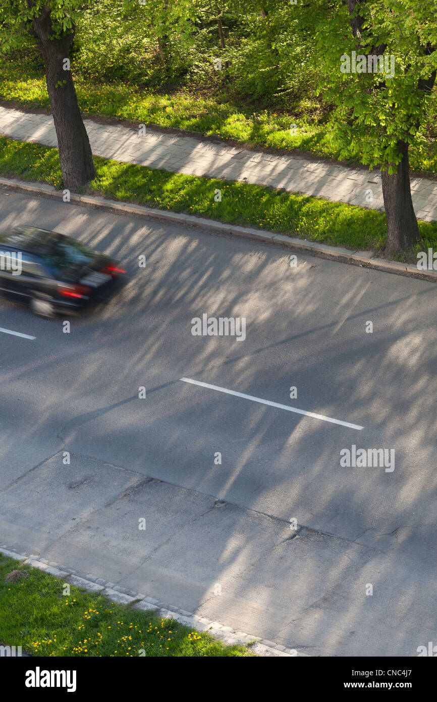 Speeding concept - Cars moving fast on a road on a lovely sunny day ...