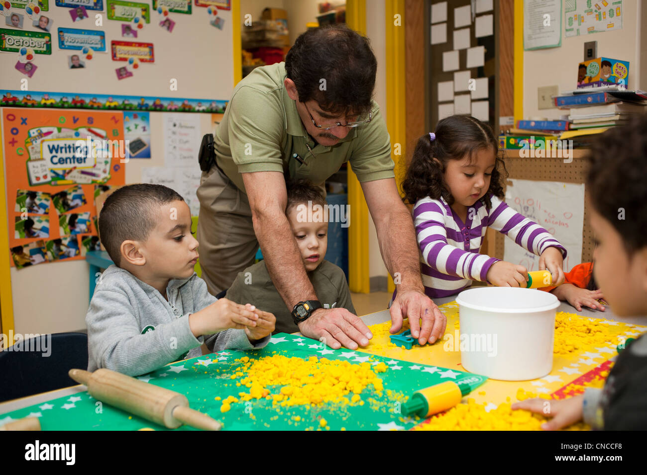Preschool classroom male teacher and students Stock Photo - Alamy