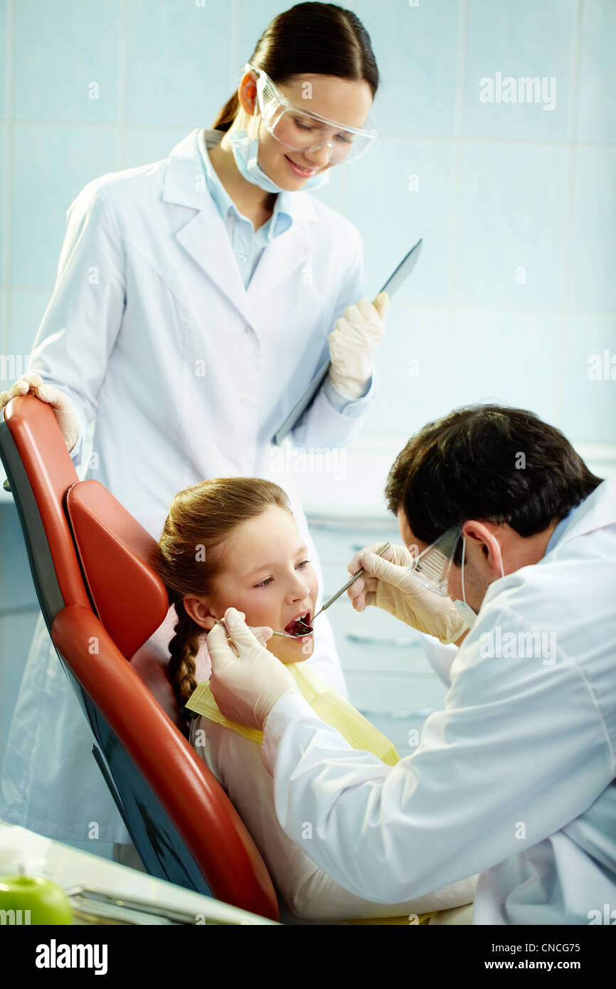 Young patient undergoing usual check-up procedure at dentist’s Stock ...