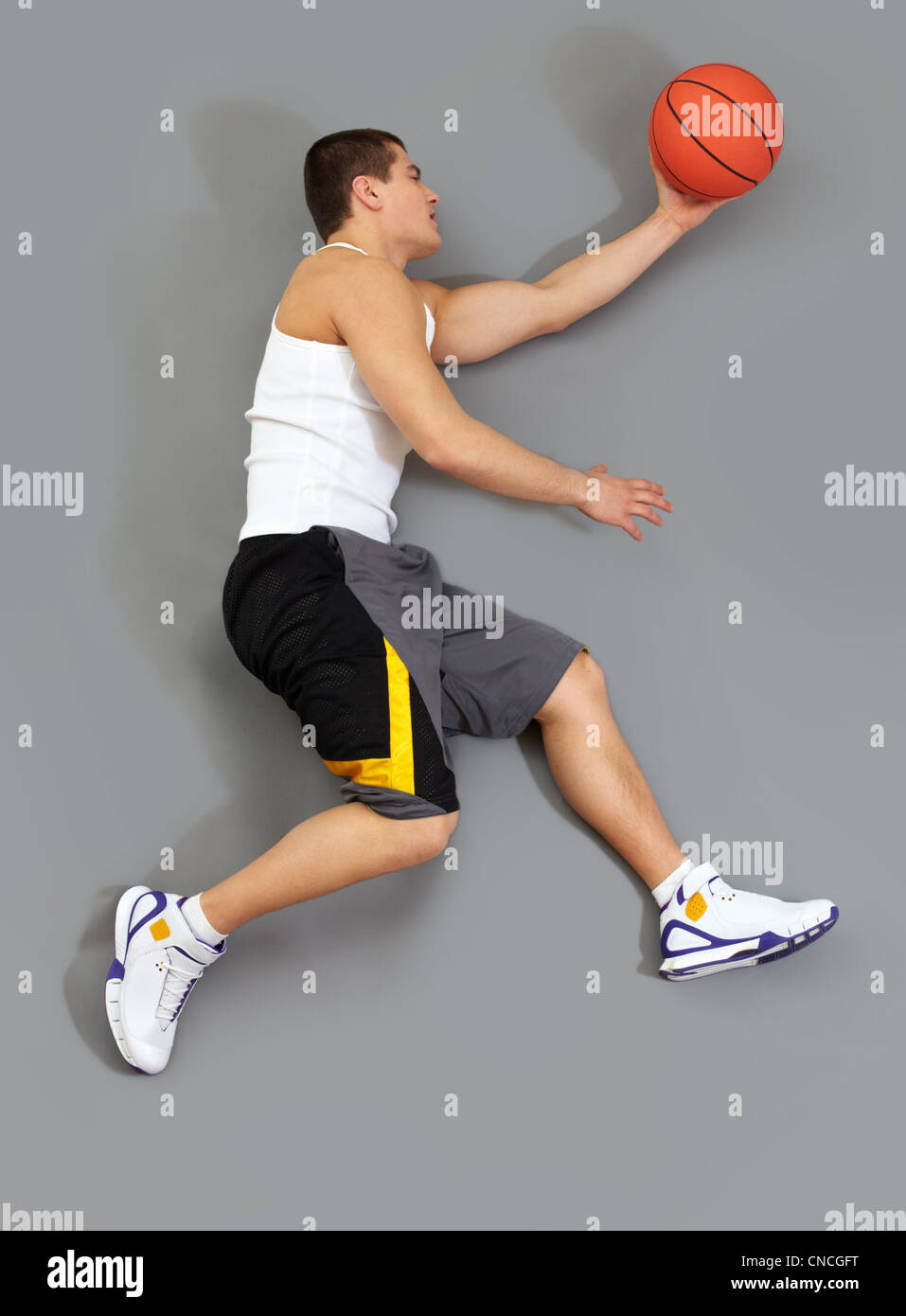 Muscular basketball player catching the ball, overview Stock Photo - Alamy