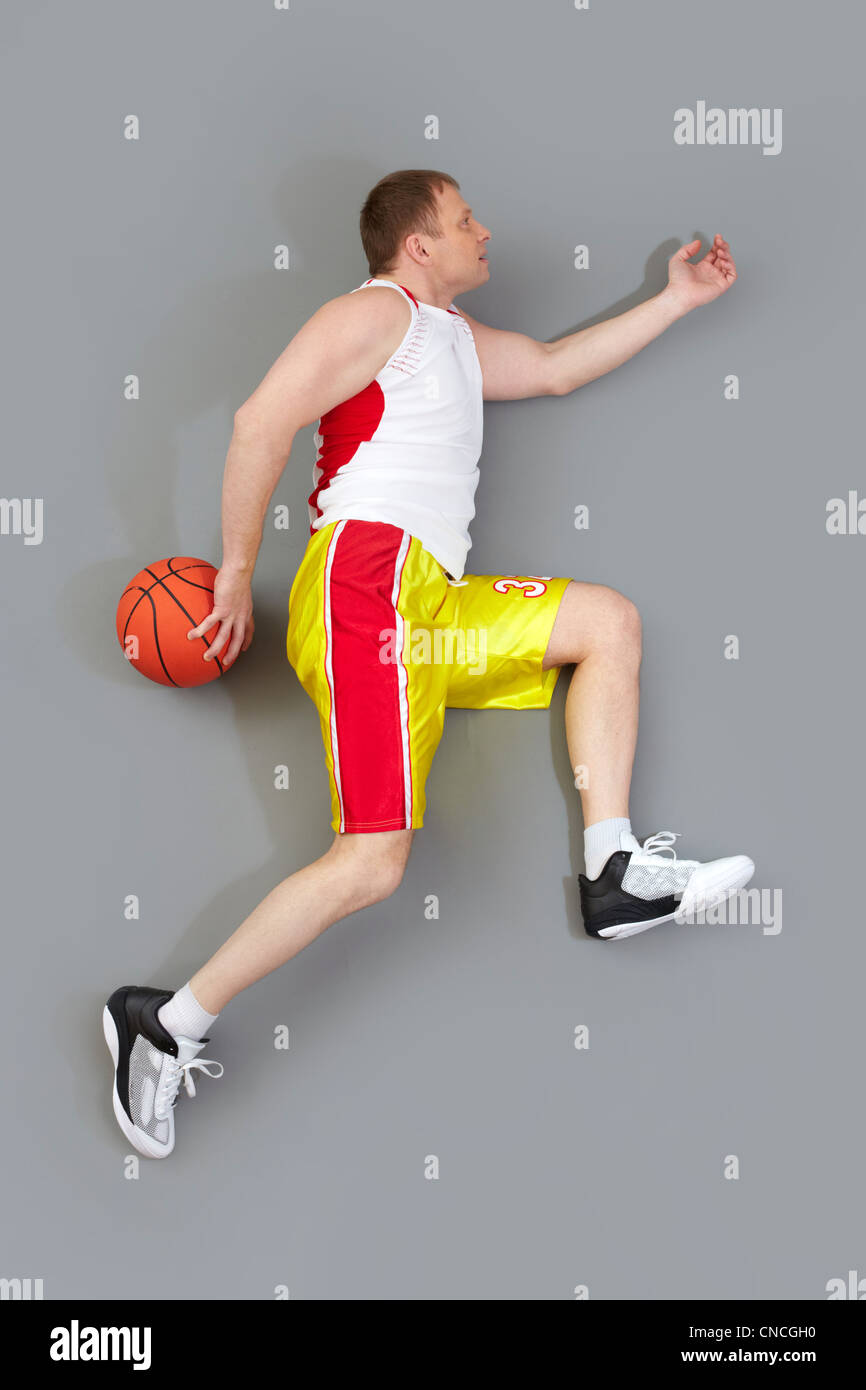 Basketball player jumping high being ready to throw the ball into ...