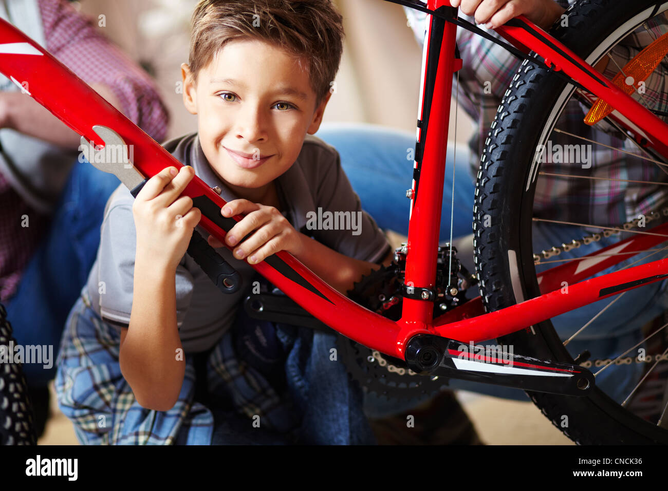 Portrait of cute boy with bicycle looking at camera Stock Photo - Alamy