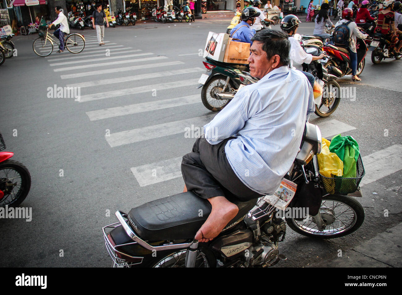 Man watching traffic go by on the street of Saigon, Vietnam Stock Photo ...