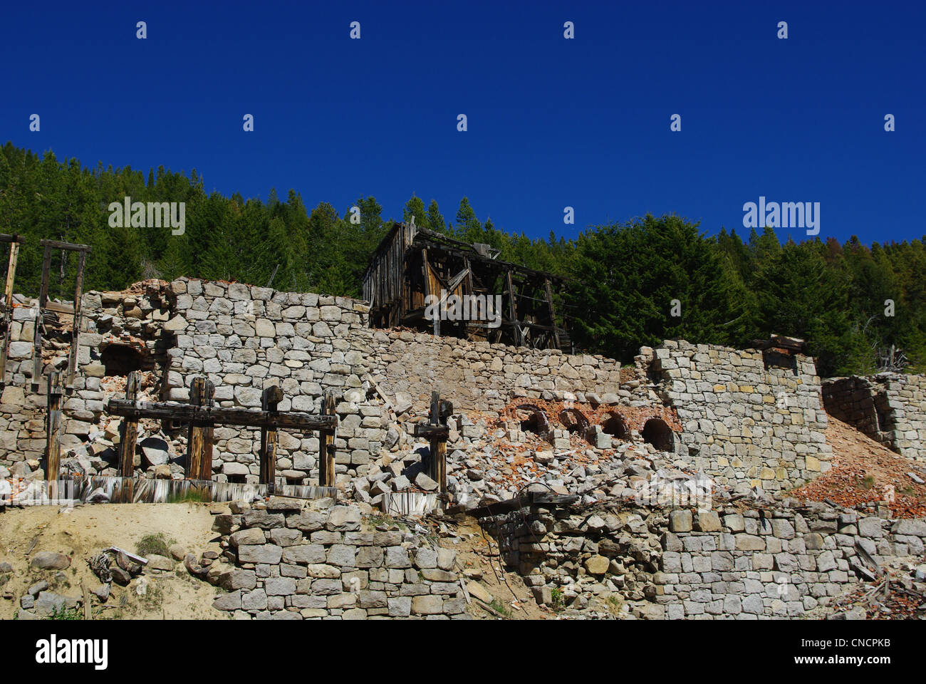 Old mine building, forest and blue sky, ghost town Granite, Montana ...