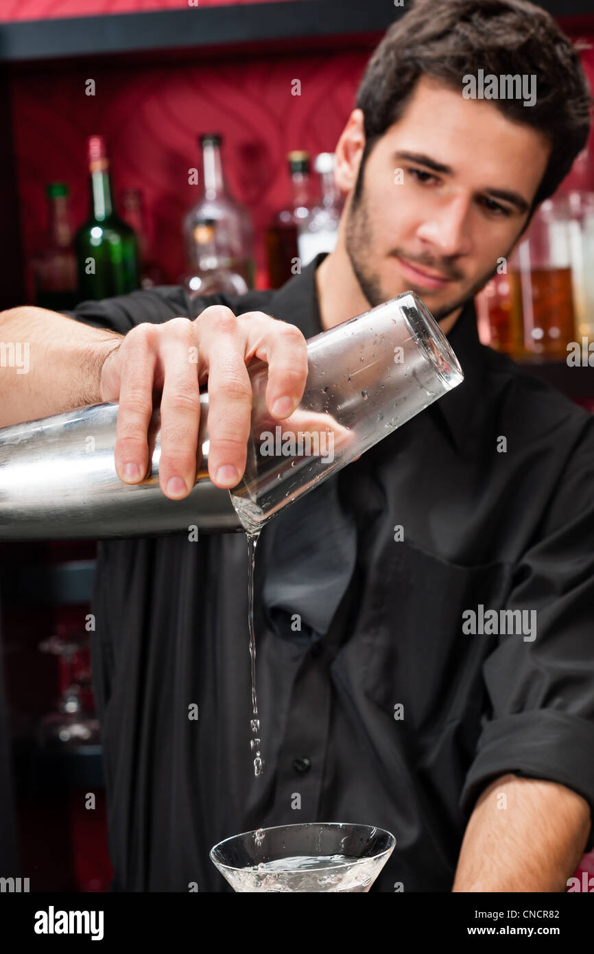 Handsome barman professional at posh bar making cocktail drinks Stock ...