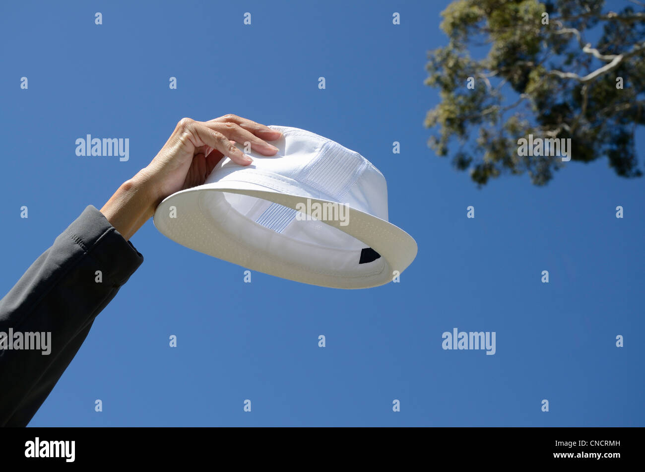 Hand holding hat brim hi-res stock photography and images - Alamy
