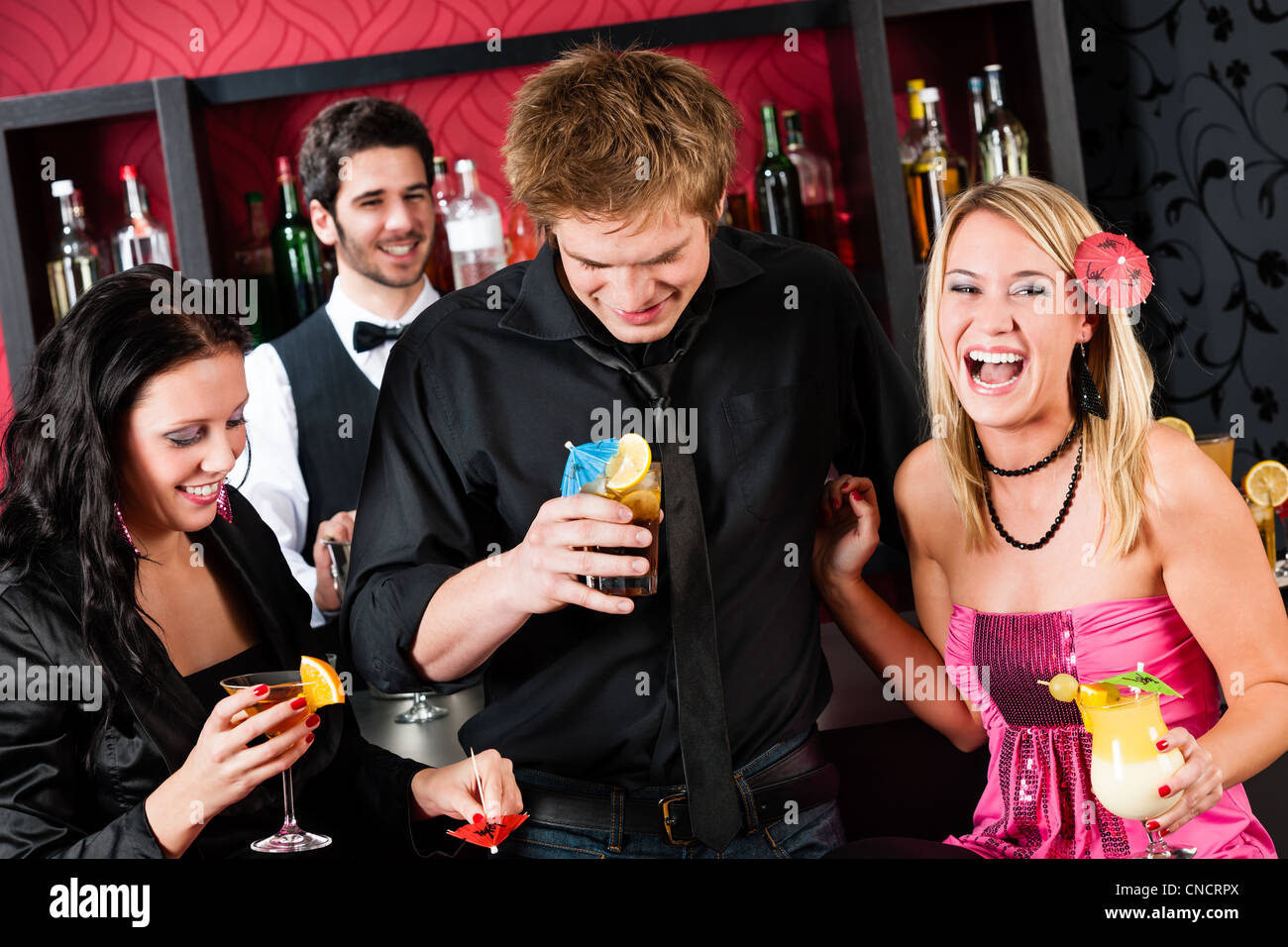 Cocktail bar laughing friends having fun at party time Stock Photo - Alamy