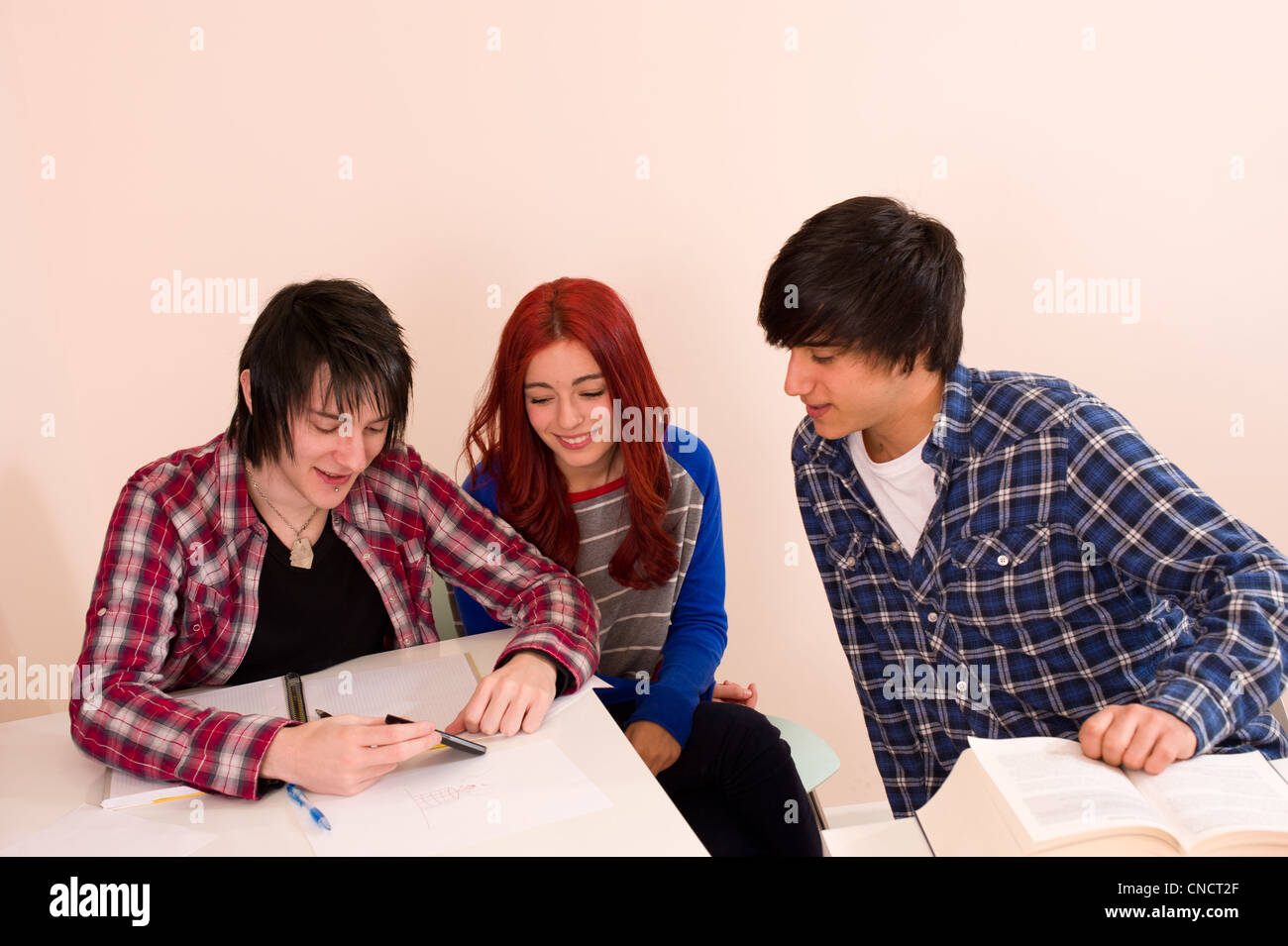 Getting distracted with the smartphone while studying Stock Photo - Alamy