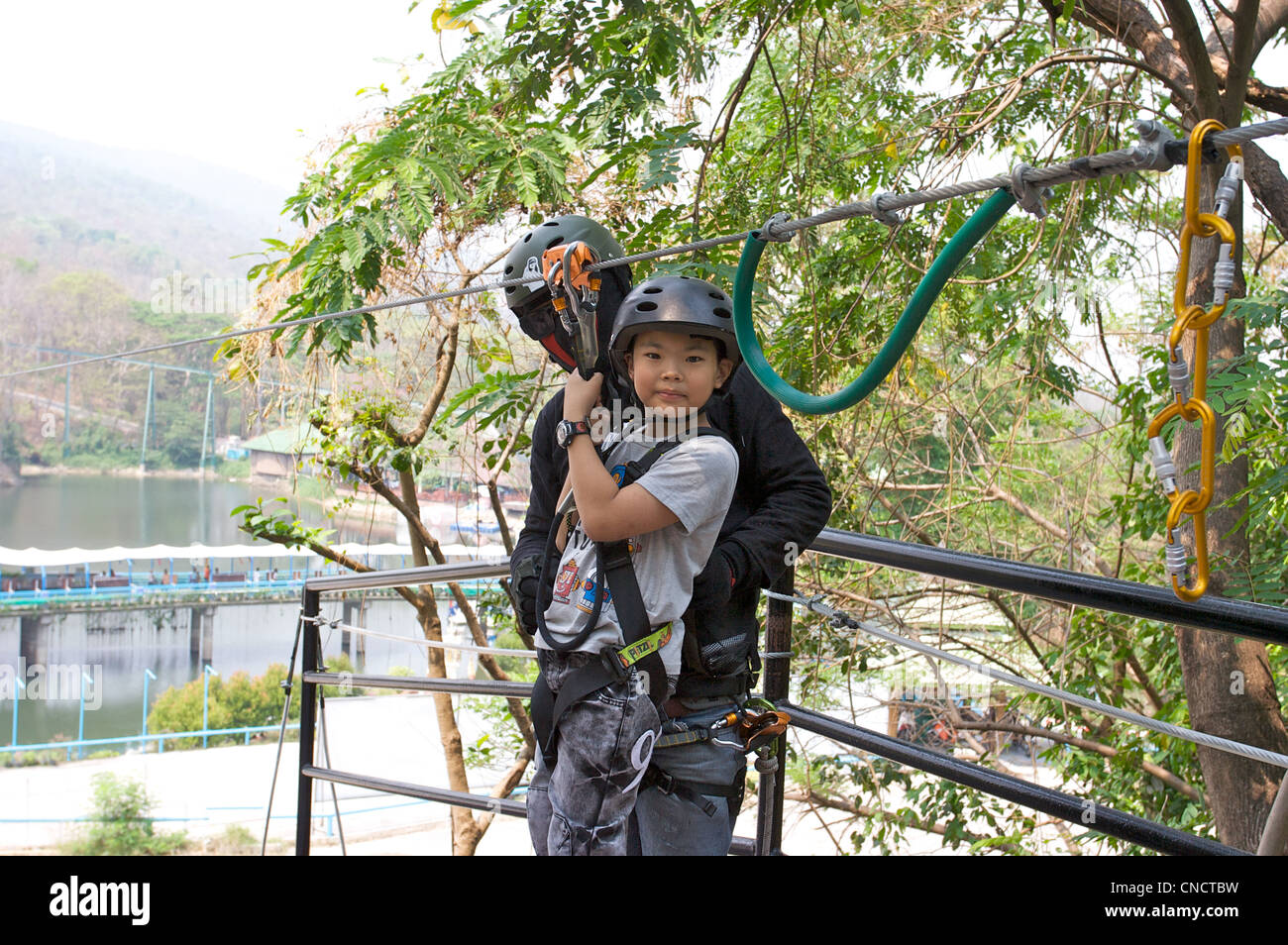 Boy getting ready for sliding down a zip line, Chiang Mai zoo, Chiang ...
