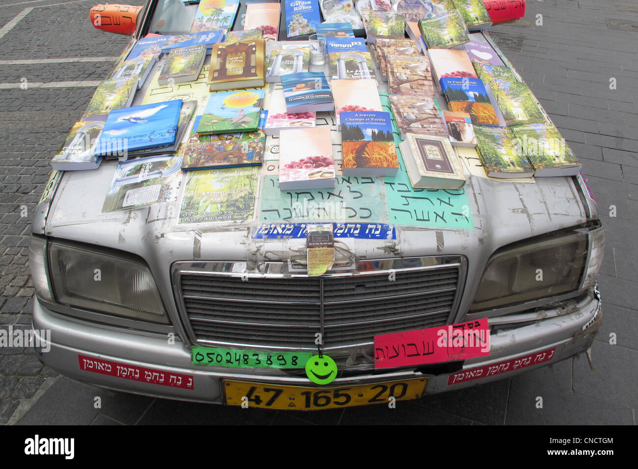 A car covered with Jewish religious tale books and booklets in downtown ...