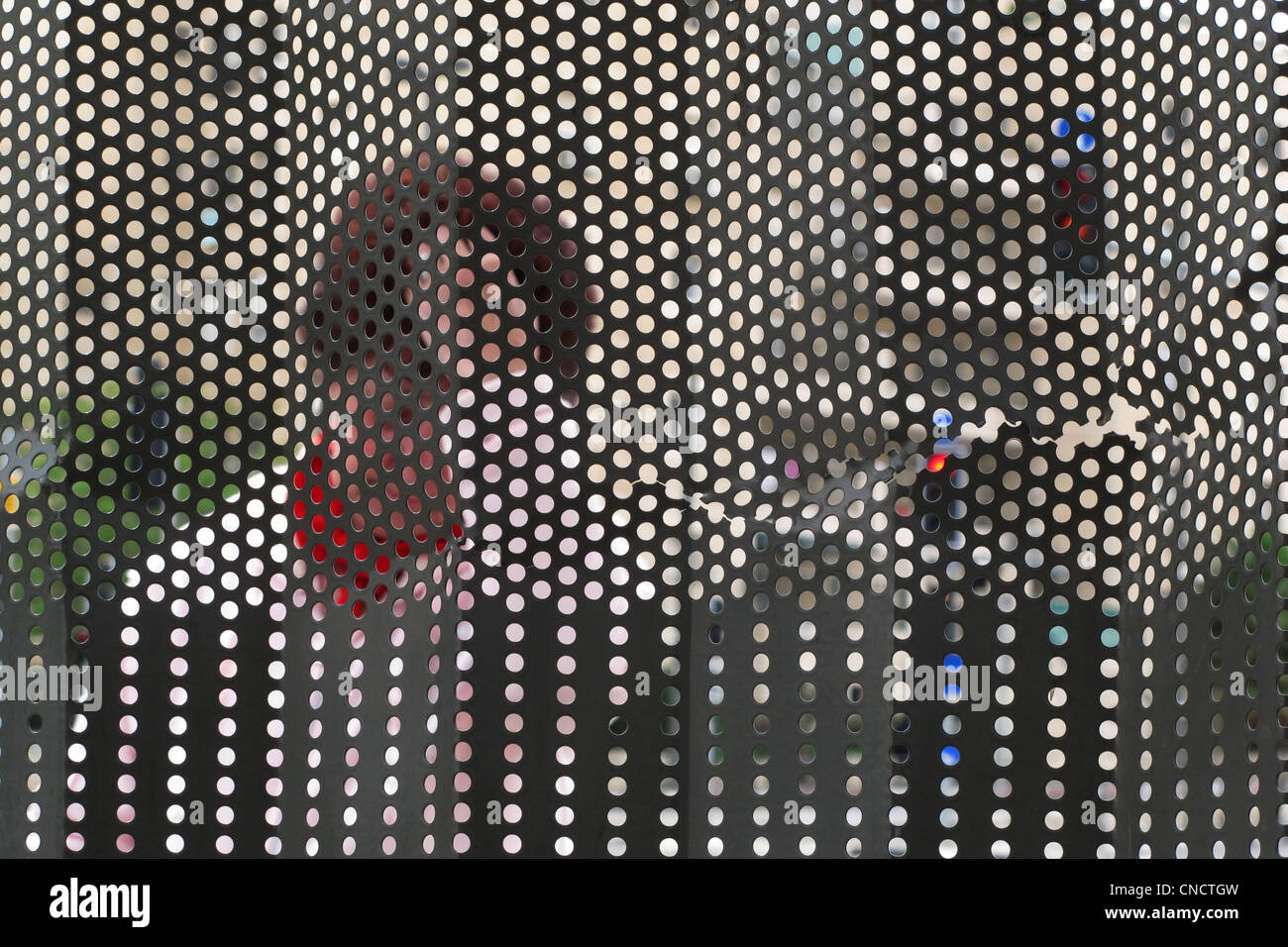 A woman is seen through perforated bus station in West Jerusalem Israel ...