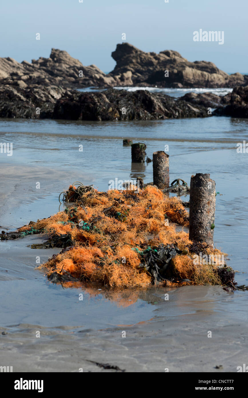 Discarded nylon fishing net wrapped around rusty steel posts Stock ...