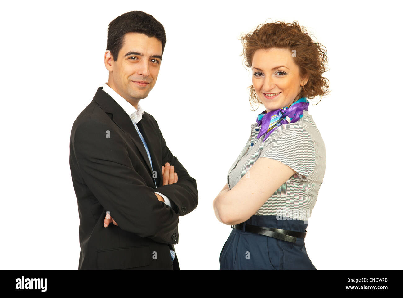 Happy couple of business people standing with arms folded isolated on ...