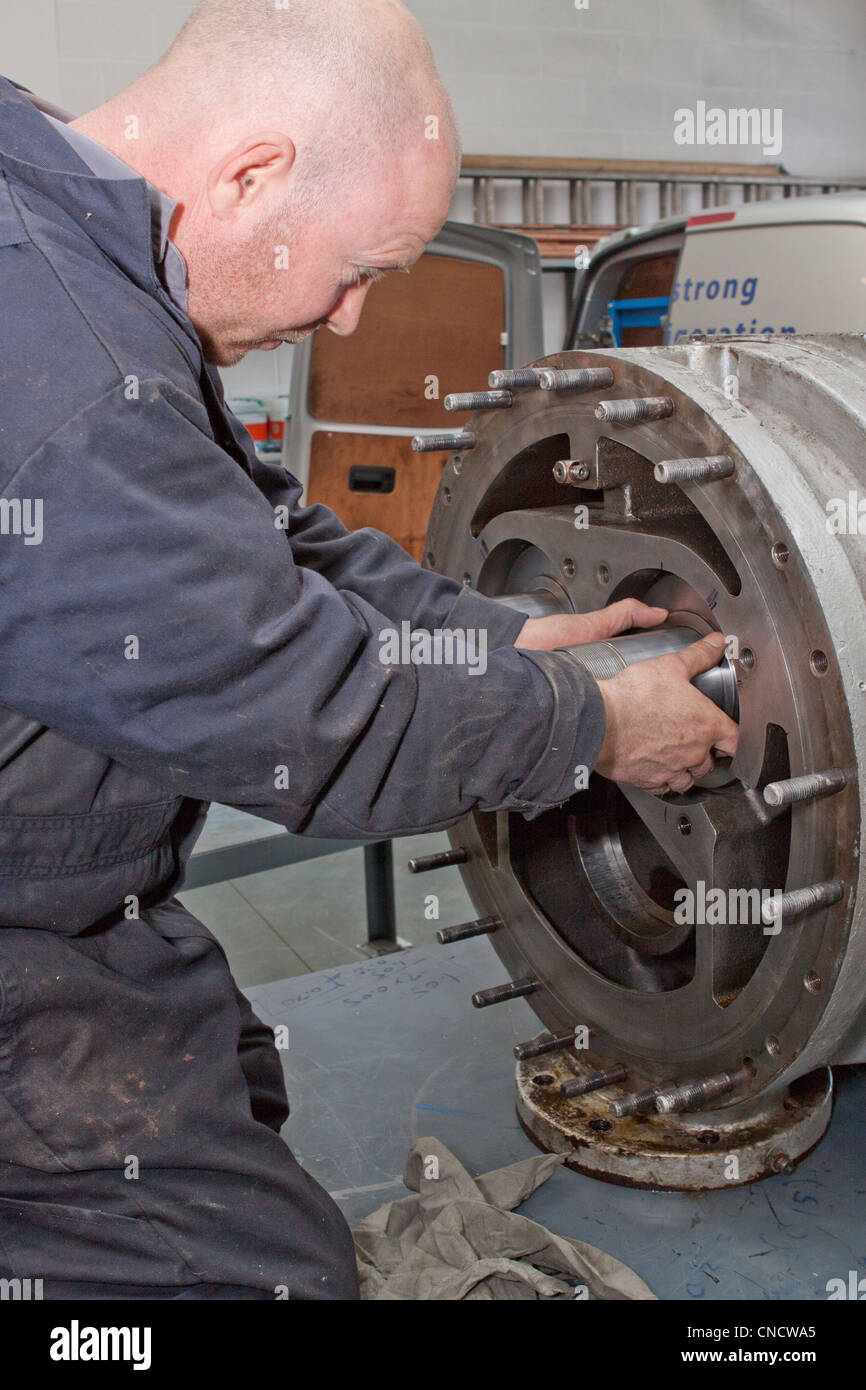 Engineers working on a heavy duty pump Stock Photo - Alamy