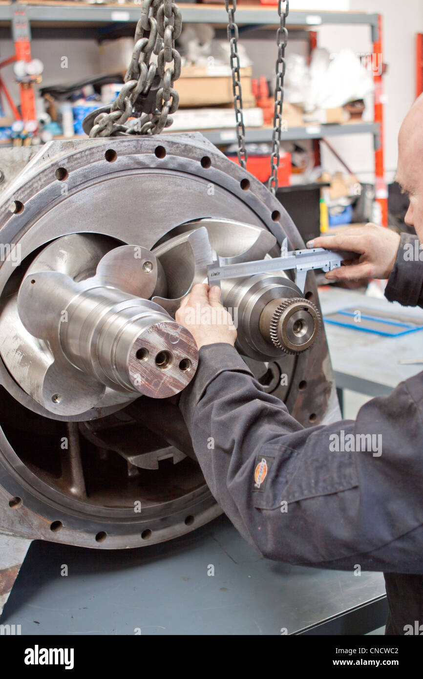 Engineers working on a heavy duty pump Stock Photo - Alamy