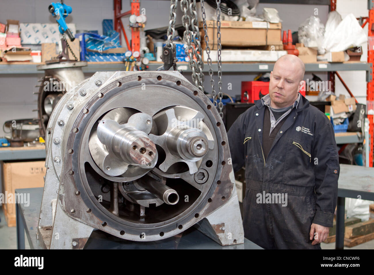 Engineers working on a heavy duty pump Stock Photo - Alamy