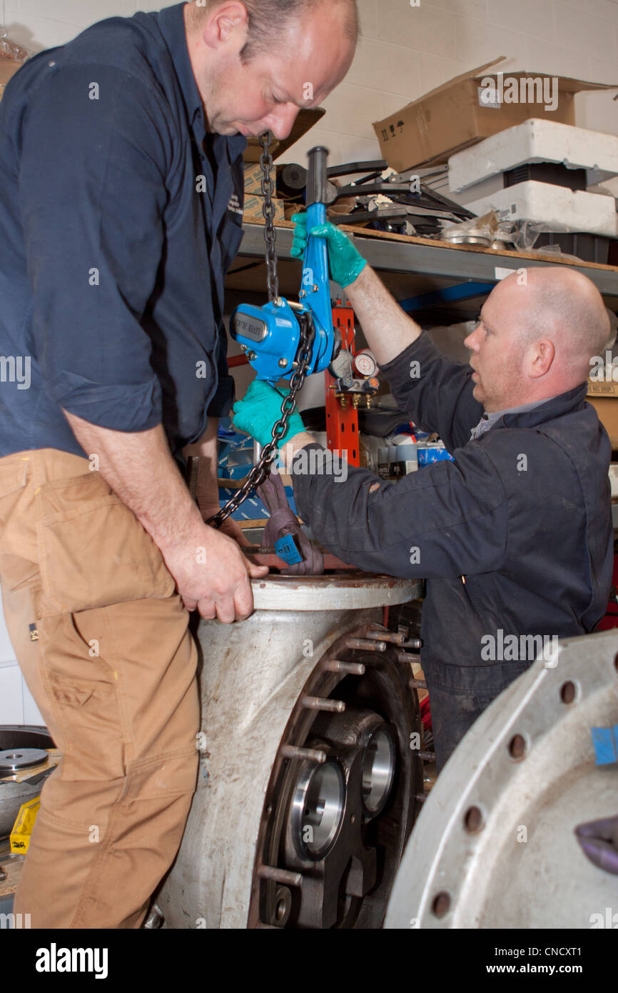 Engineers working on a heavy duty pump Stock Photo - Alamy