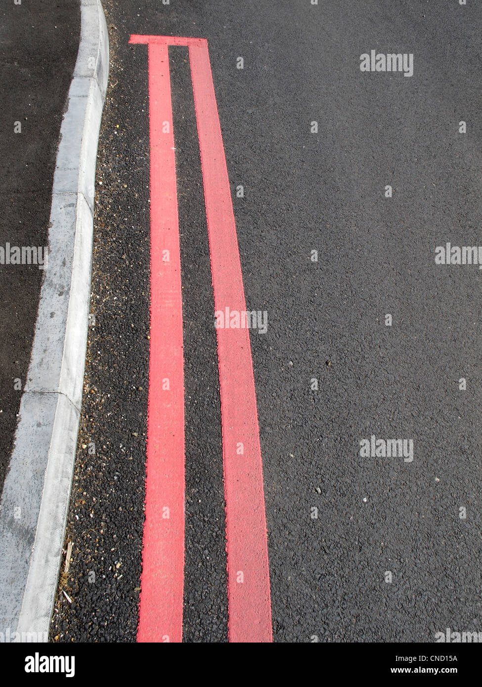 Red route 'no stopping' road marking Stock Photo - Alamy
