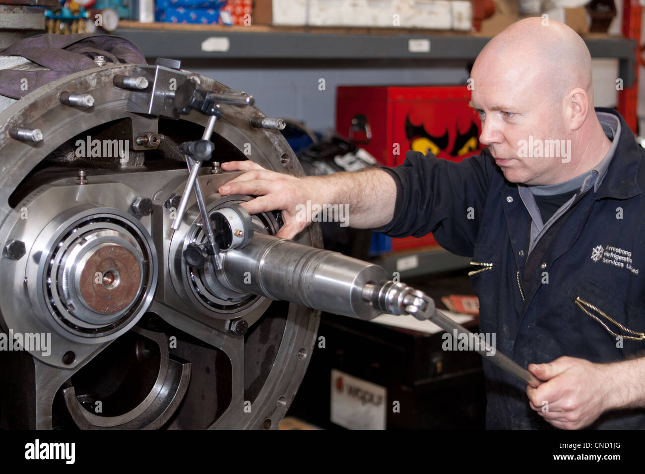 Engineer repairing heavy mechanical equipment Stock Photo - Alamy