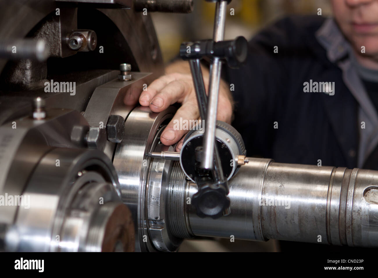 Engineer repairing heavy mechanical equipment Stock Photo - Alamy