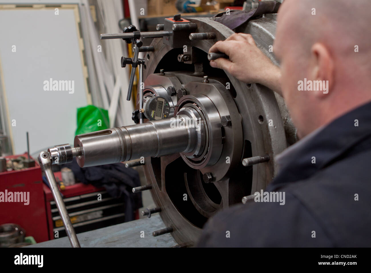 Engineer repairing heavy mechanical equipment Stock Photo - Alamy
