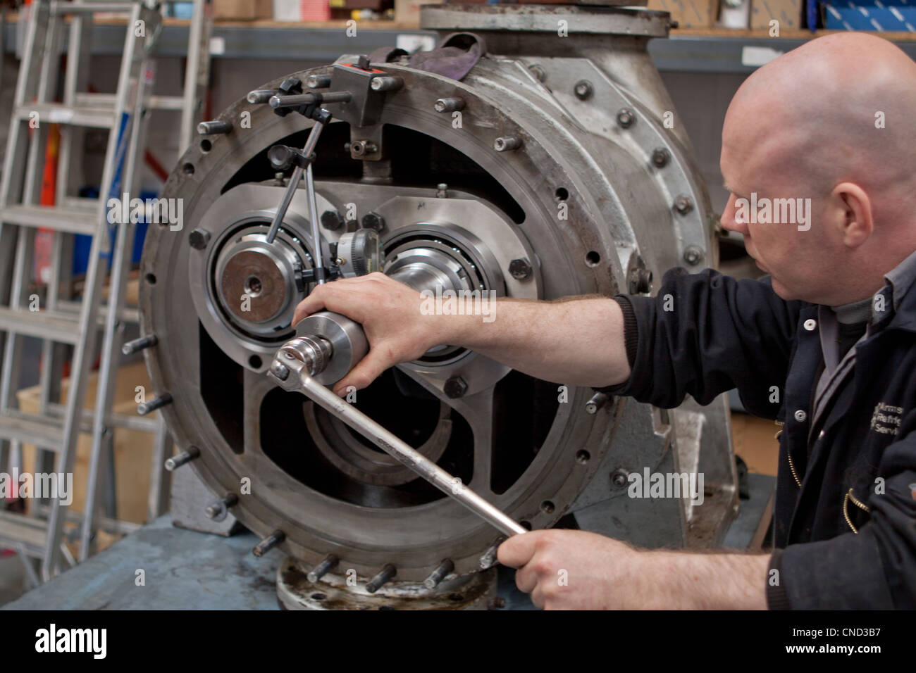 Engineer repairing heavy mechanical equipment Stock Photo - Alamy