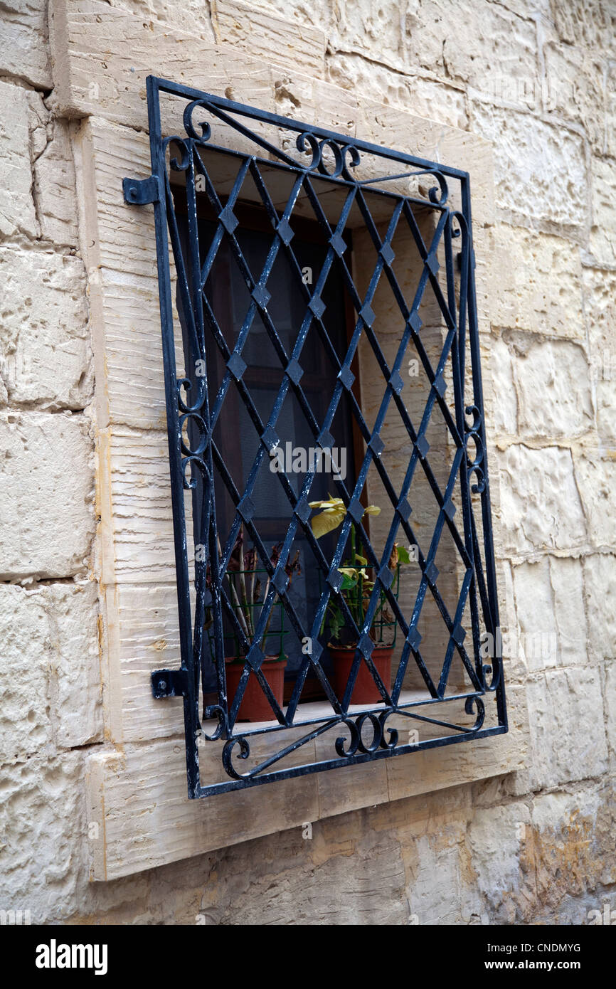 Window covered with wrought iron Stock Photo - Alamy