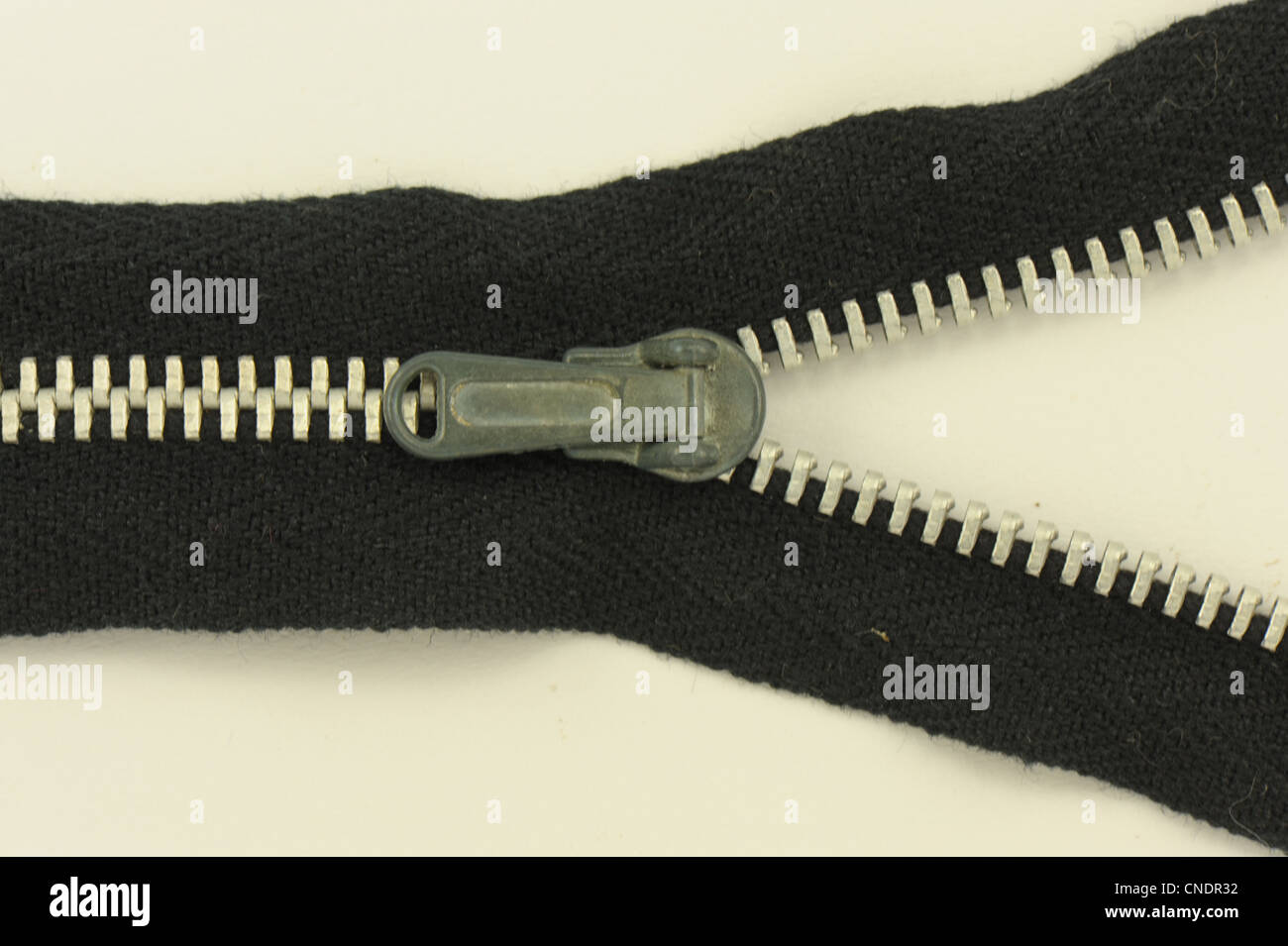 zips cloth opened to show teeth taken on a white background Stock Photo ...