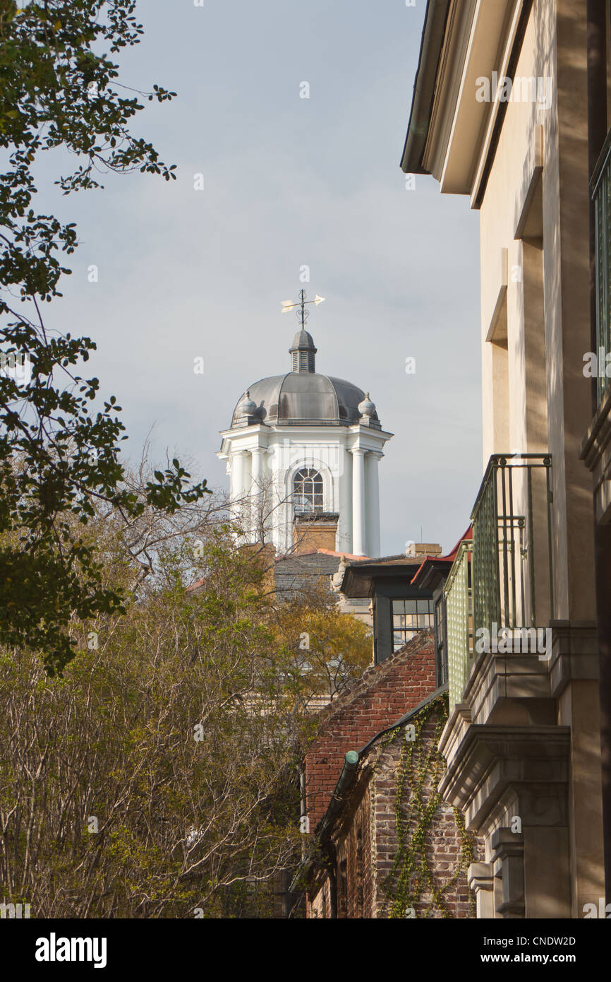 The cuppola of the Old Exchange Building rises above a quiet street in ...