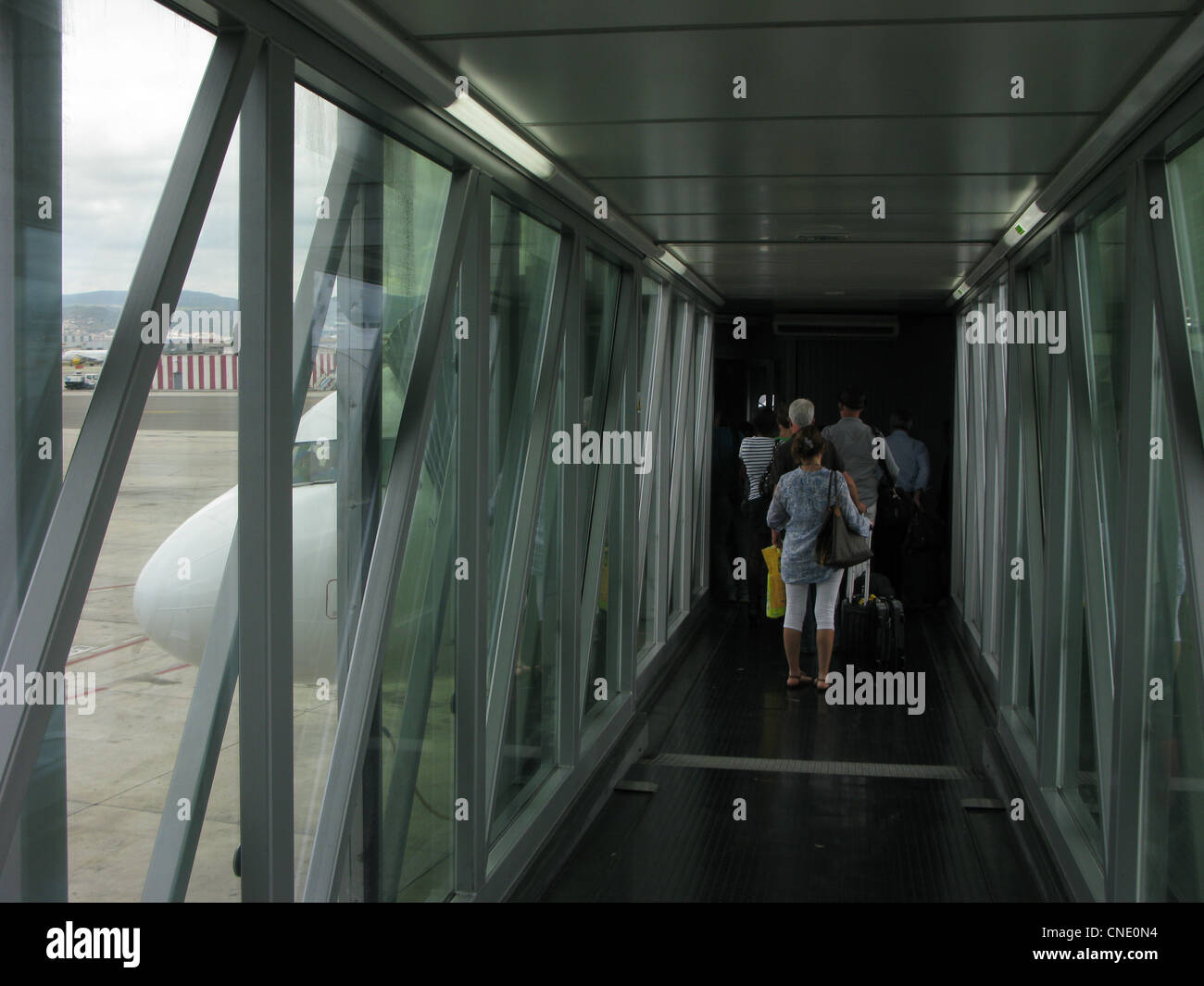 passengers boarding plane by finger dock Stock Photo - Alamy