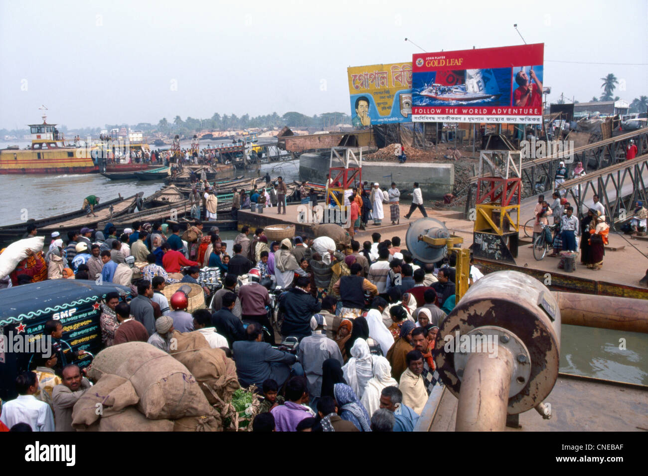 Buriganga. A crowded ferry arrives in Dhaka with a load of people and ...