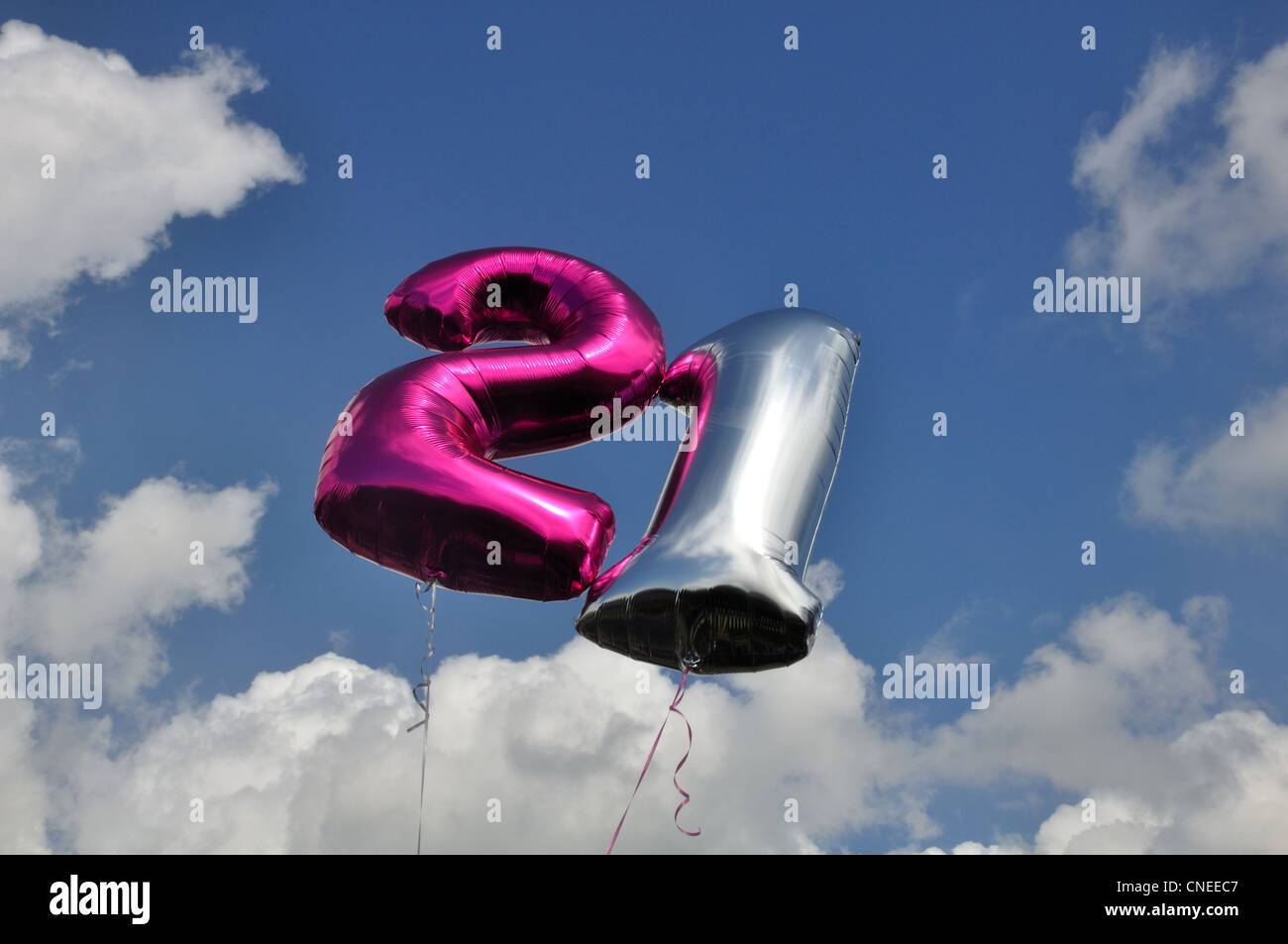 Twenty First birthday balloons floating in a blue sky Stock Photo - Alamy