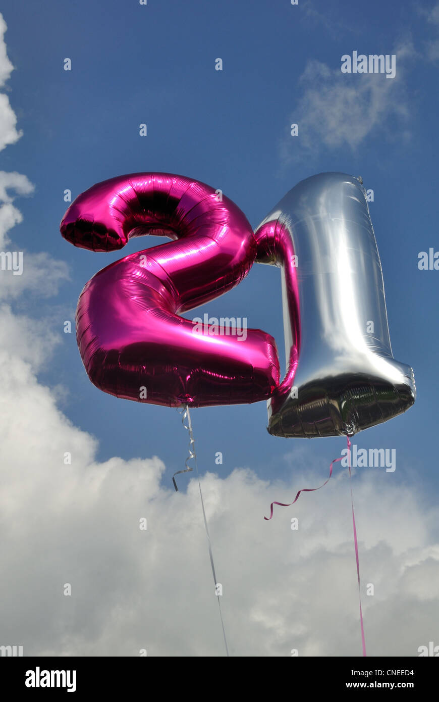 Twenty First birthday balloons floating in a blue sky Stock Photo - Alamy