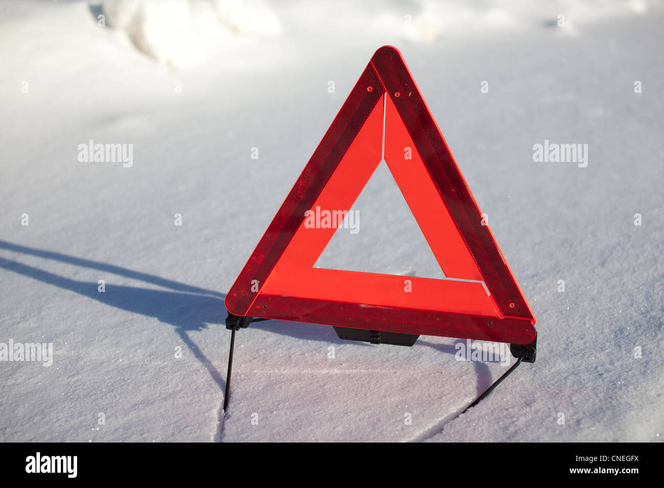 warning triangle on snow Stock Photo - Alamy