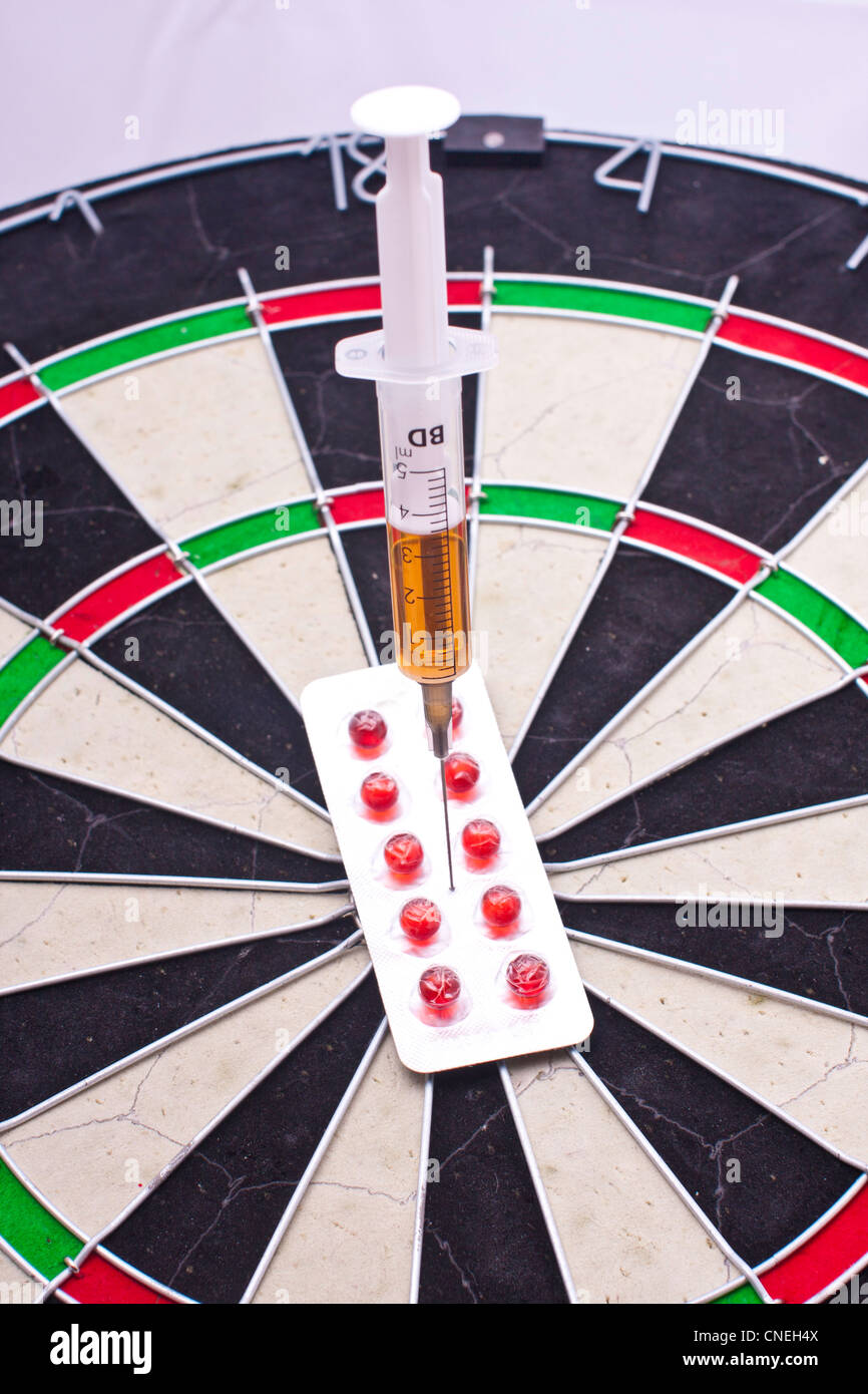 syringe in target on darts board Stock Photo - Alamy