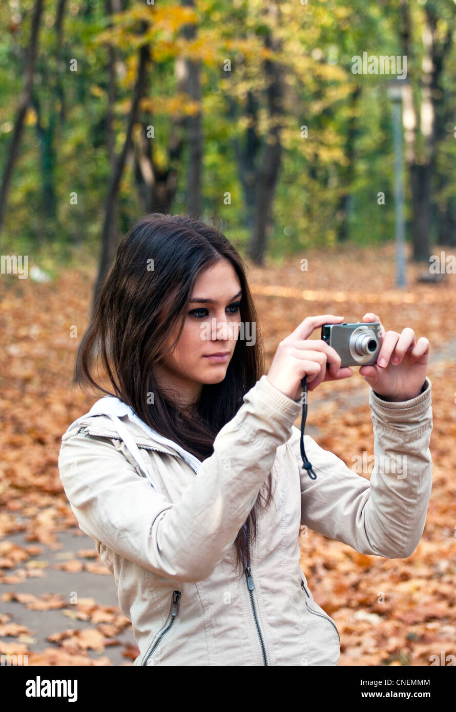 Beautiful girl taking photo with camera Stock Photo - Alamy