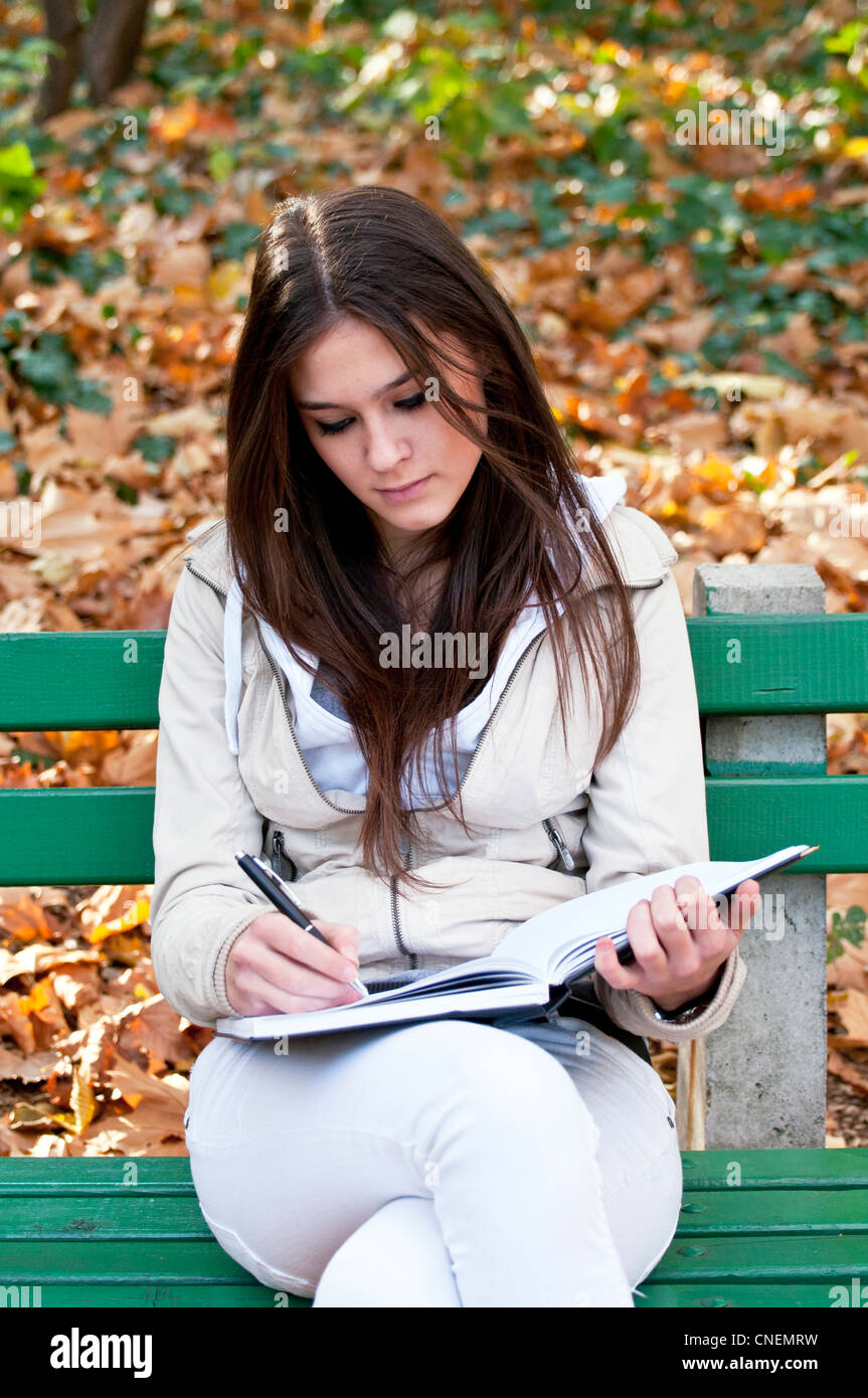 Beautiful girl studying outdoors Stock Photo - Alamy
