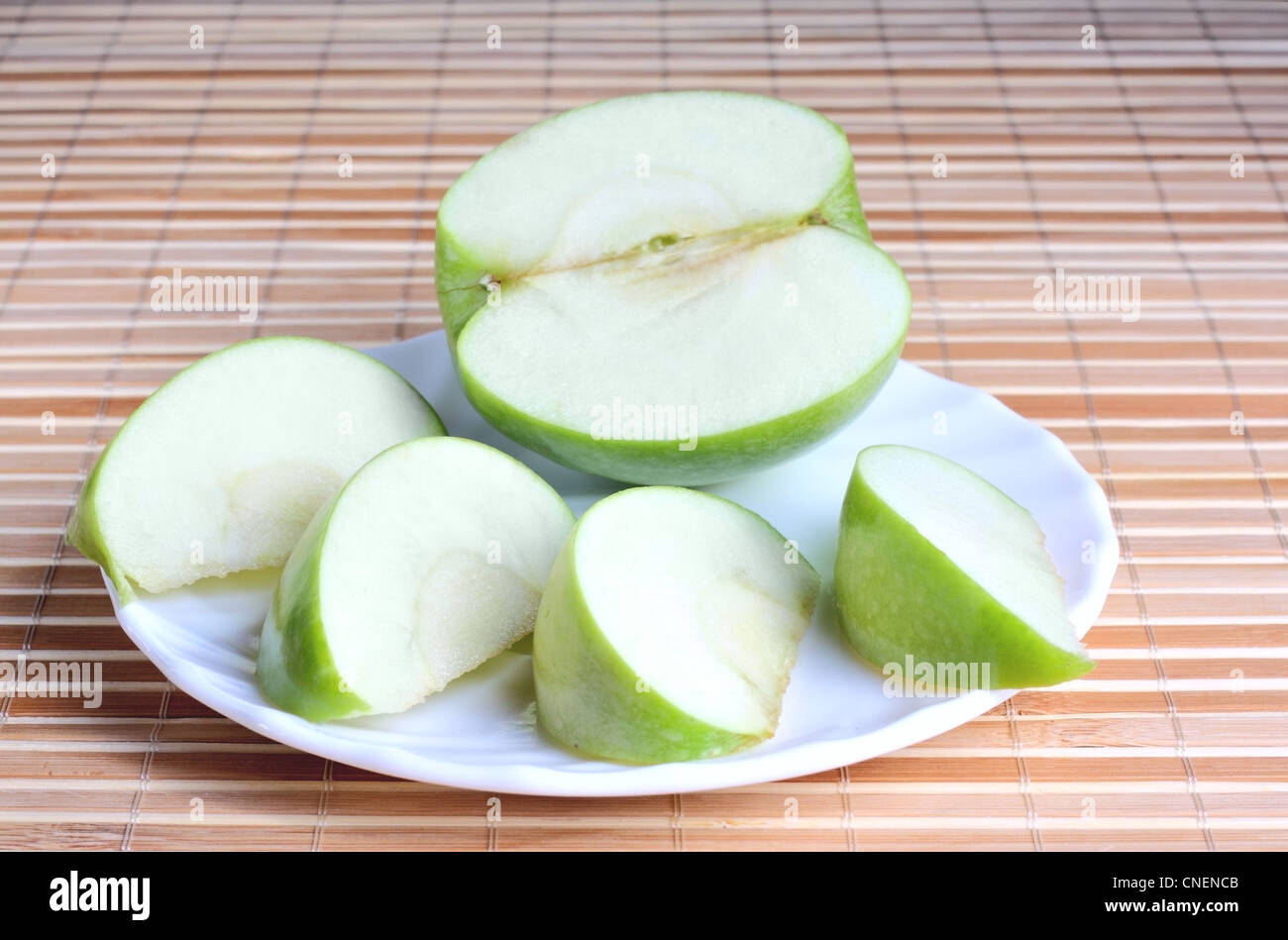Apple pieces on the plate at the textured background Stock Photo - Alamy