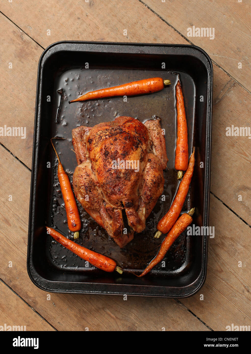 Roasted Free range chicken with roasted carrots Stock Photo - Alamy