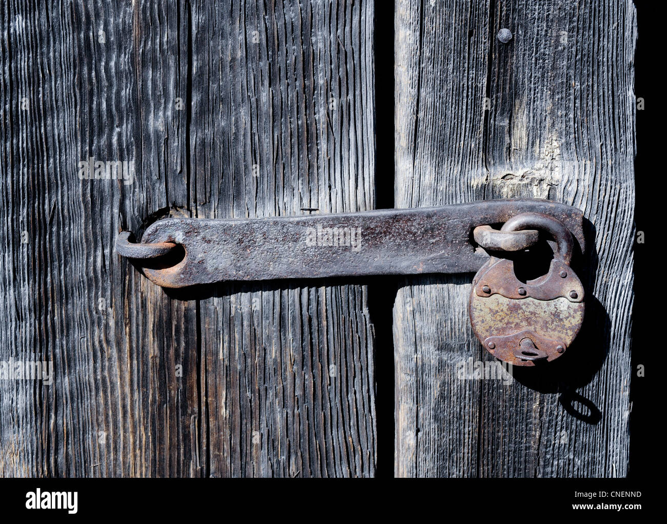 old rusty padlock with small key on a wooden door Stock Photo - Alamy