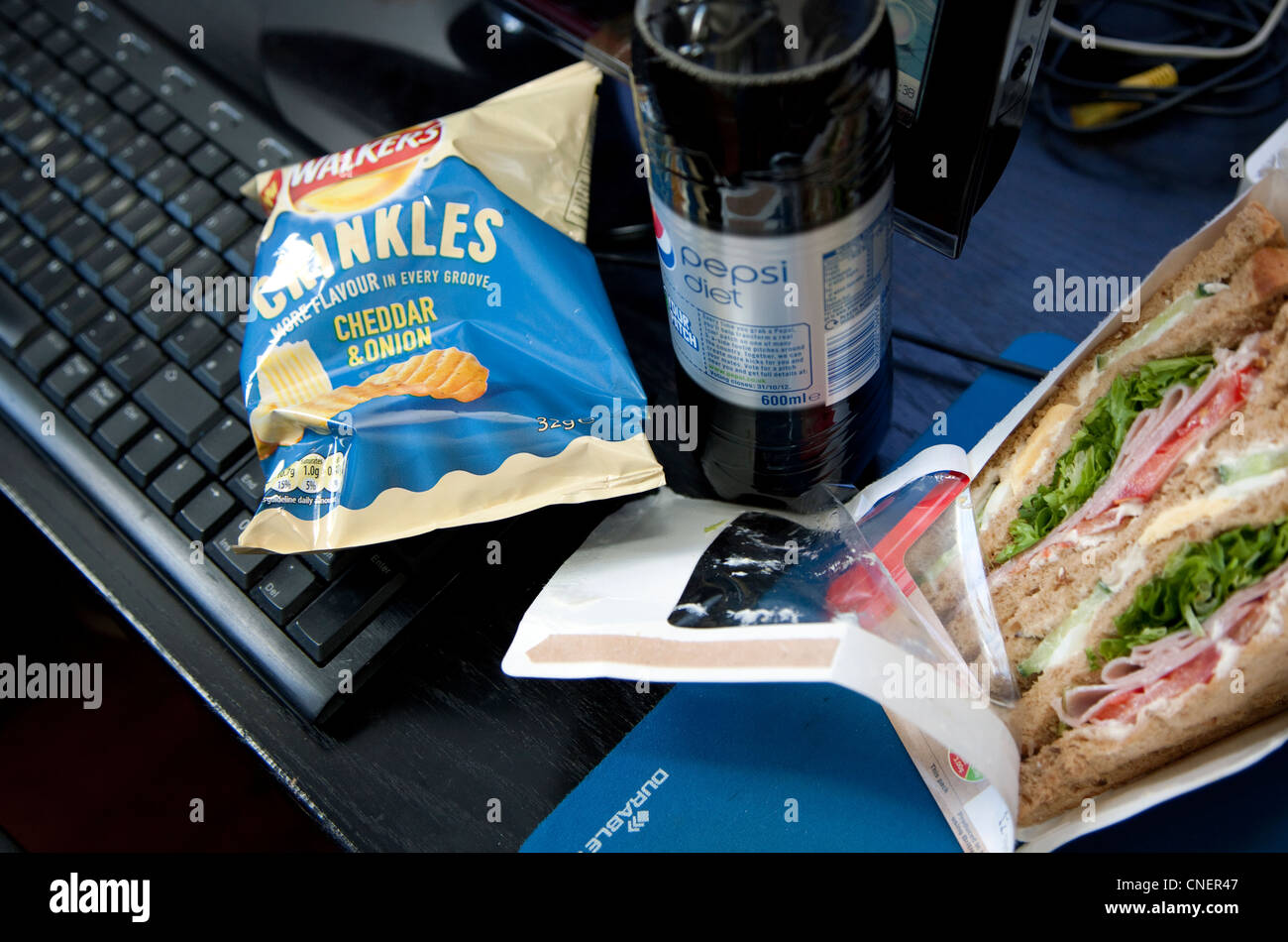 Snack lunch at office desk, London Stock Photo - Alamy